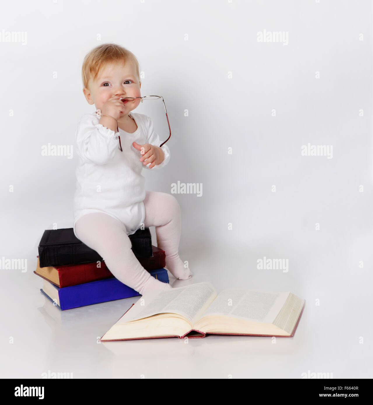 Baby with books Stock Photo - Alamy