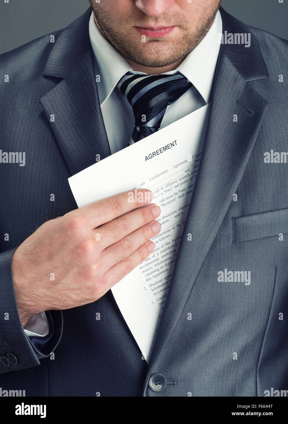 Serious businessman getting agreement from suit Stock Photo - Alamy