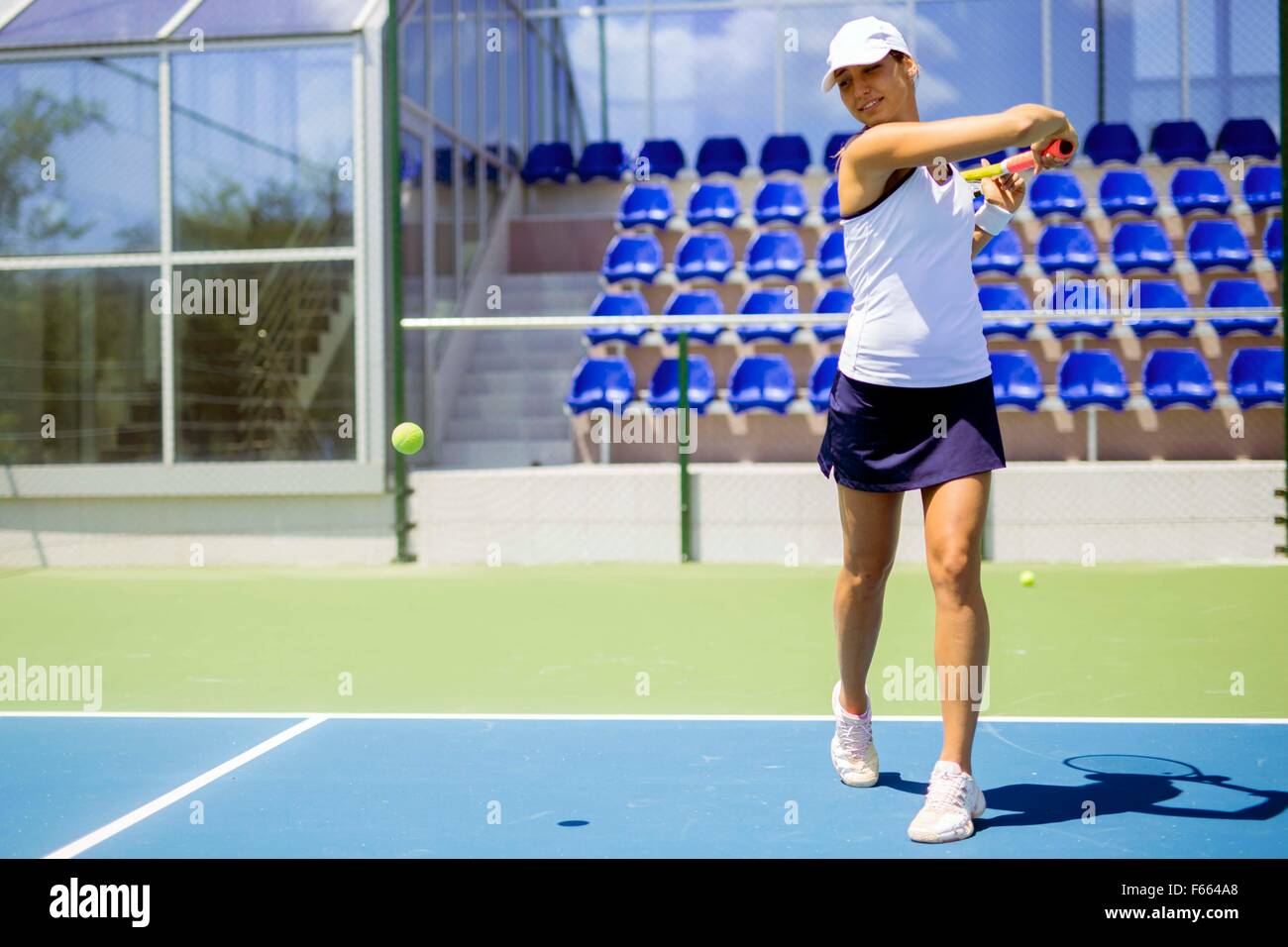 Beautiful female tennis player in action, hitting a forehand Stock ...