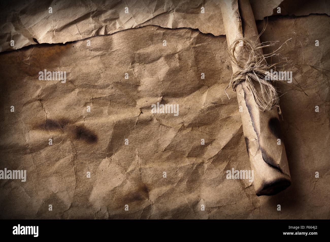 Background of old paper with rolled message Stock Photo - Alamy