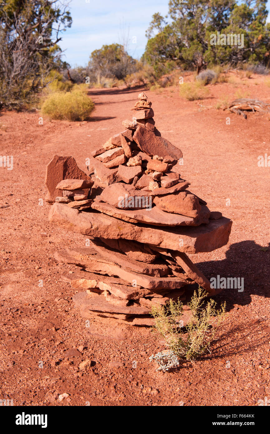 Small cairn made of red rocks on a hiking trail Stock Photo - Alamy
