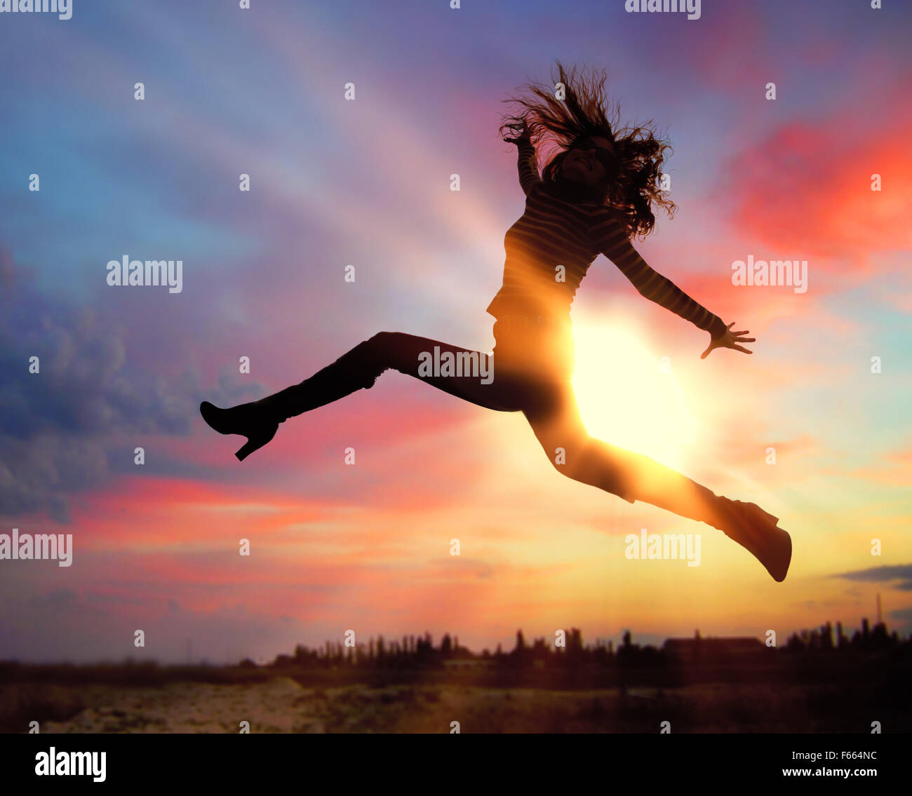 Silhouette excited woman jumping sunset hi-res stock photography and ...