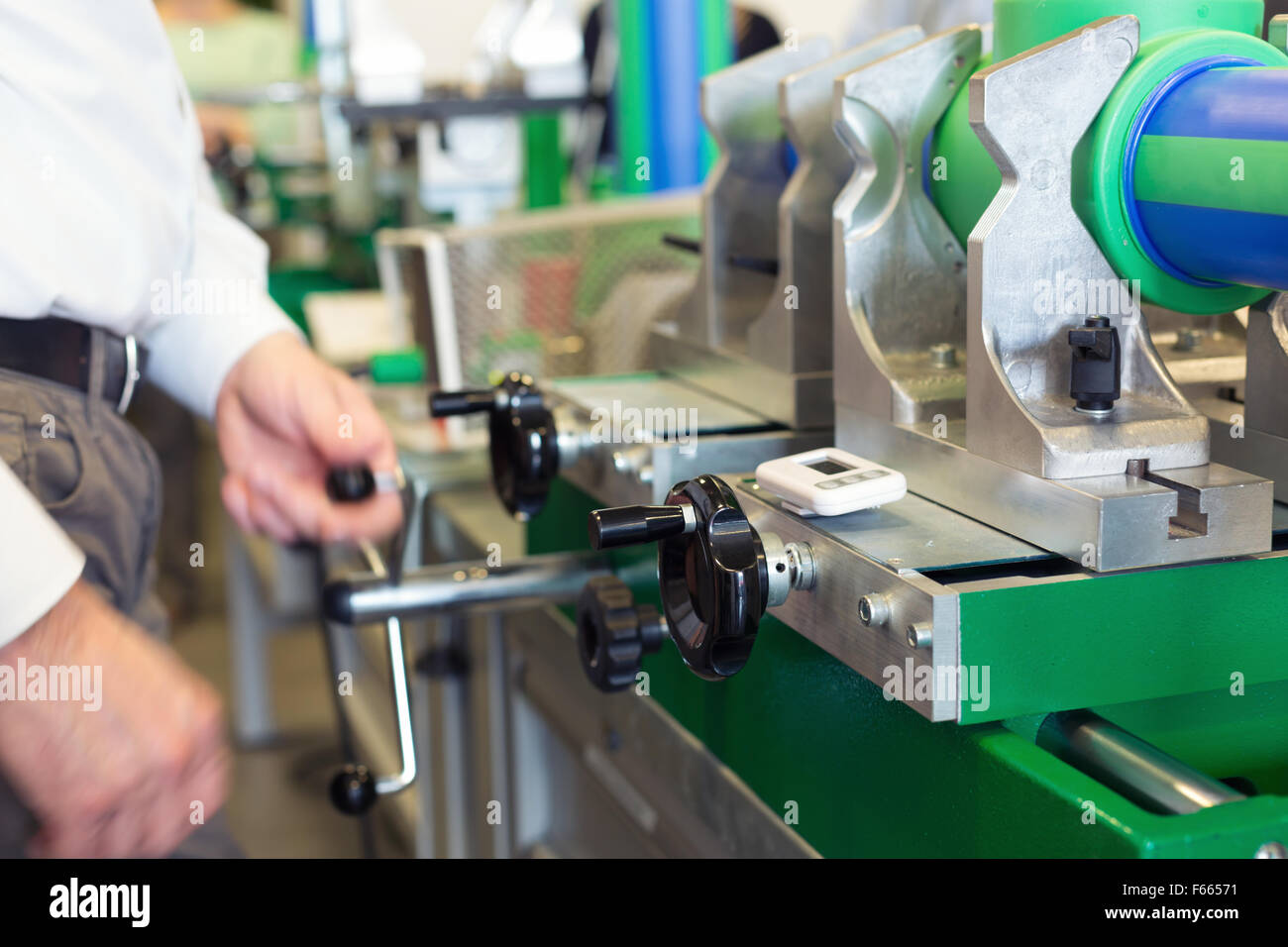 Mechanic working on a machine at workroom Stock Photo - Alamy