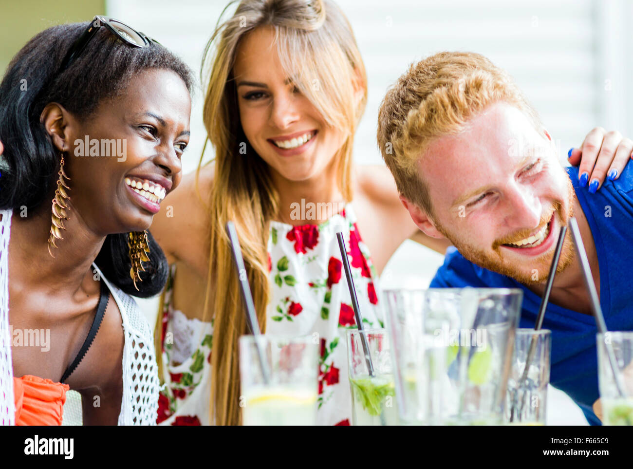 Friends laughing and hugging each other outdoors and being happy Stock ...