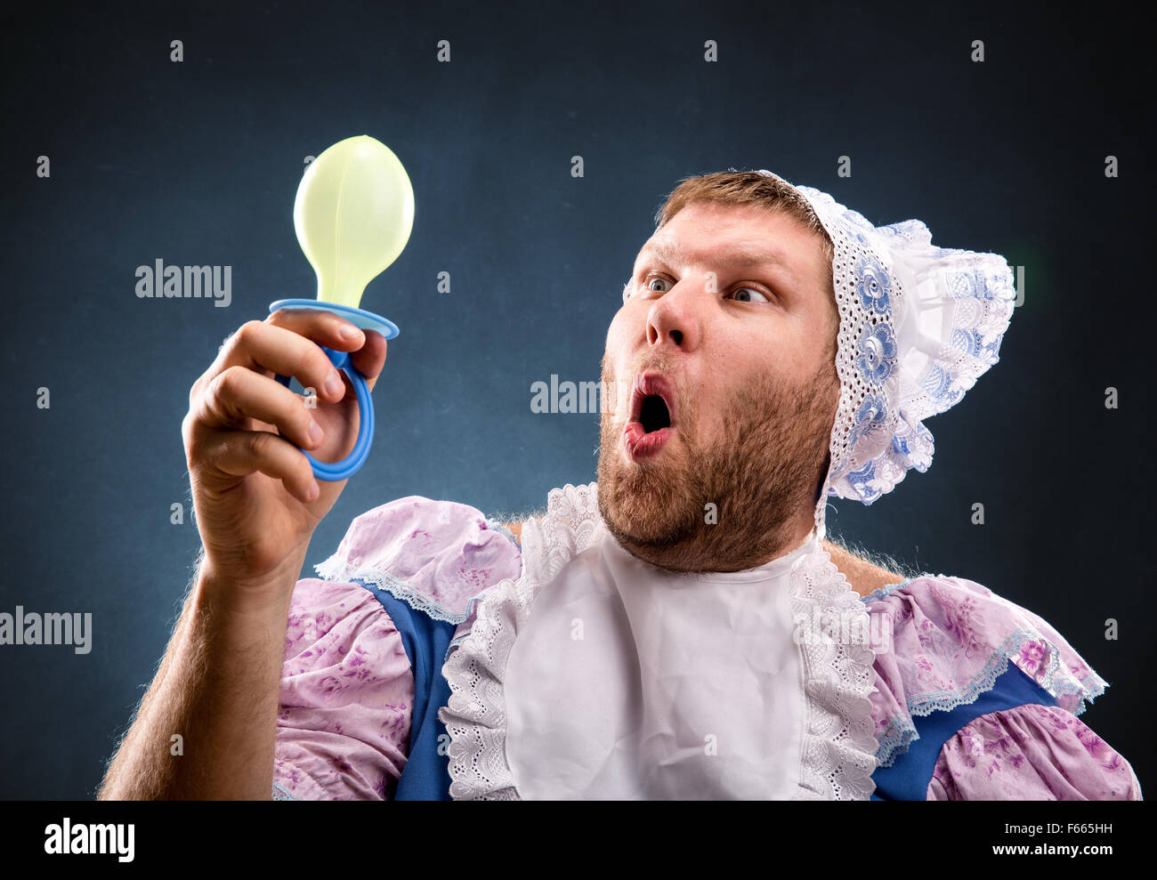 Crazy man with a pacifier in hand Stock Photo - Alamy