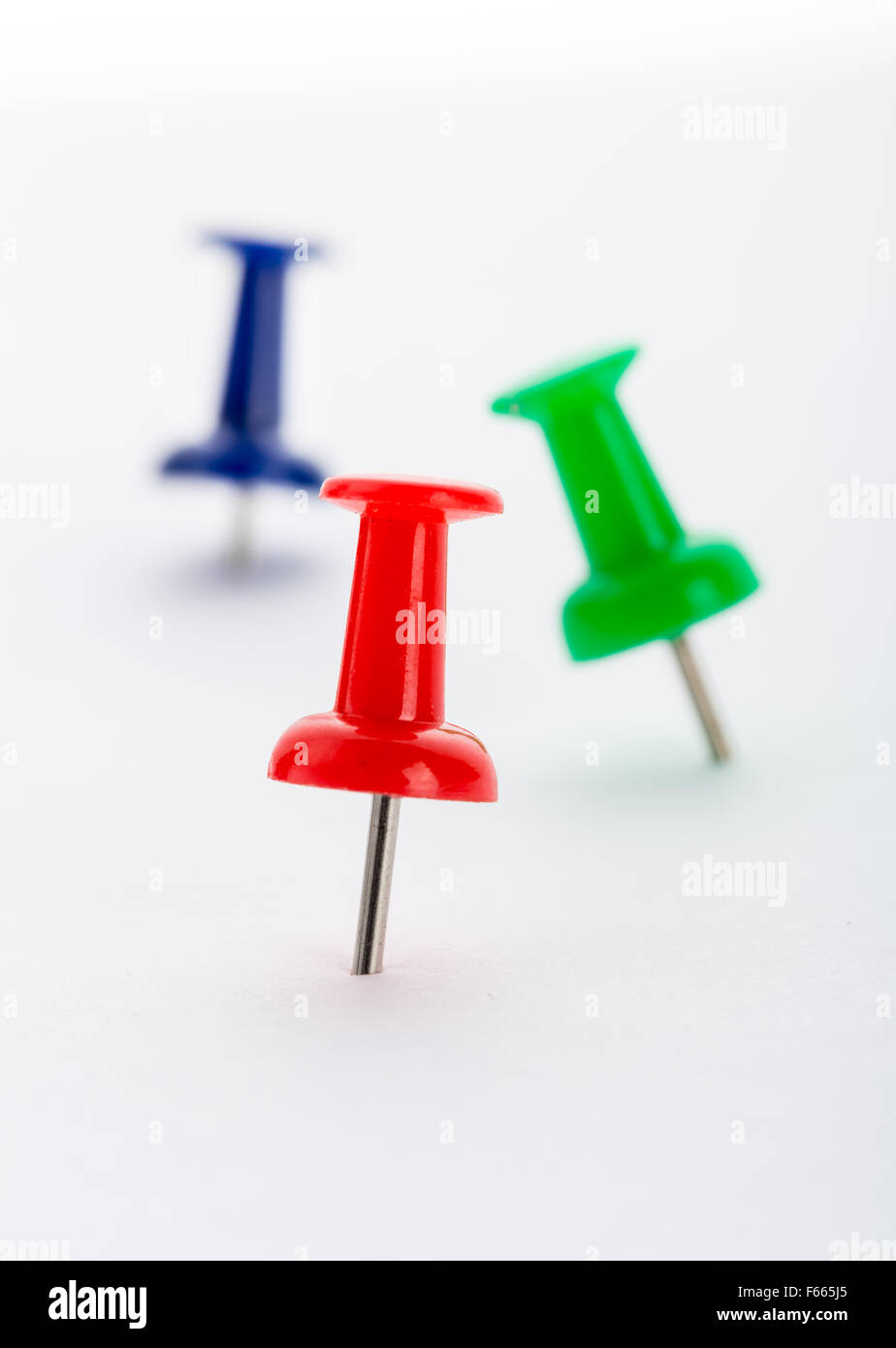 Three push-pins close-up isolated on white background Stock Photo - Alamy