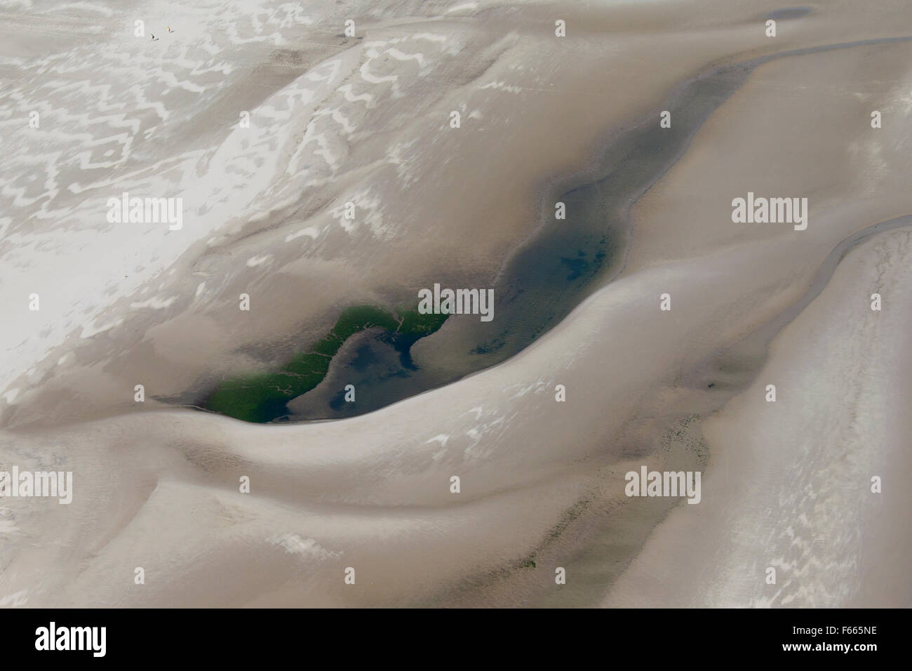 Aerial view showing walkers on tidal mud flat at the Schleswig-Holstein ...