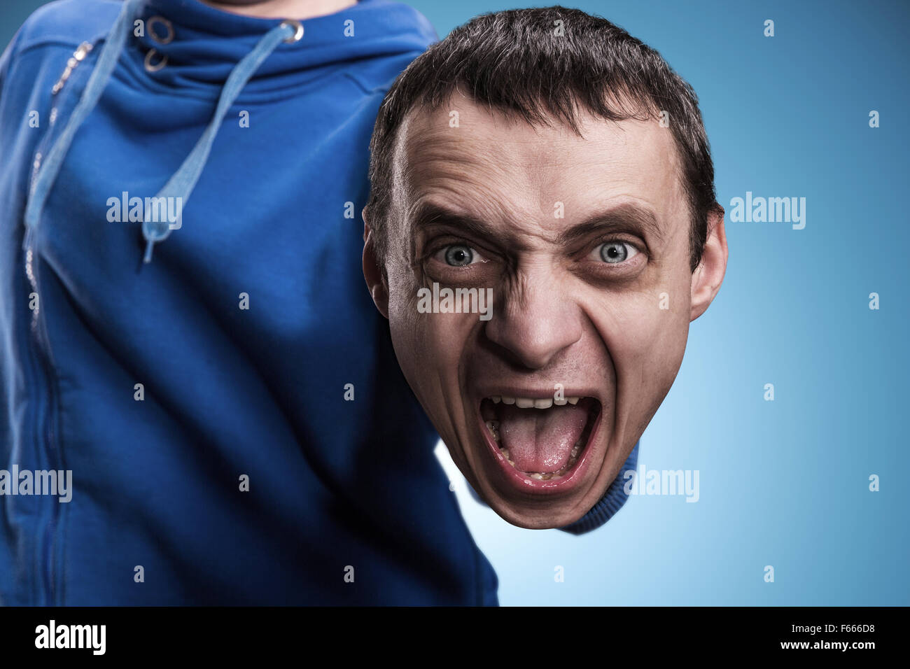 Man with screaming head instead of a palm over blue Stock Photo - Alamy