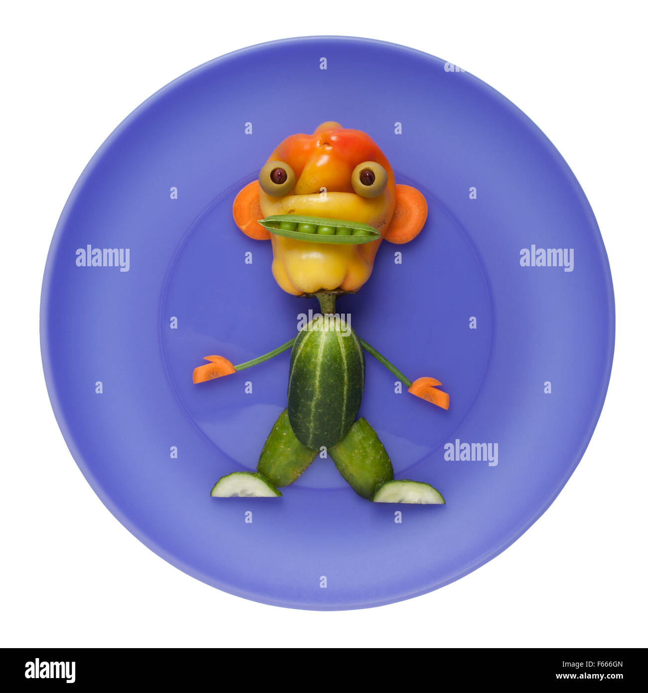 Funny vegetable monster on blue plate Stock Photo - Alamy
