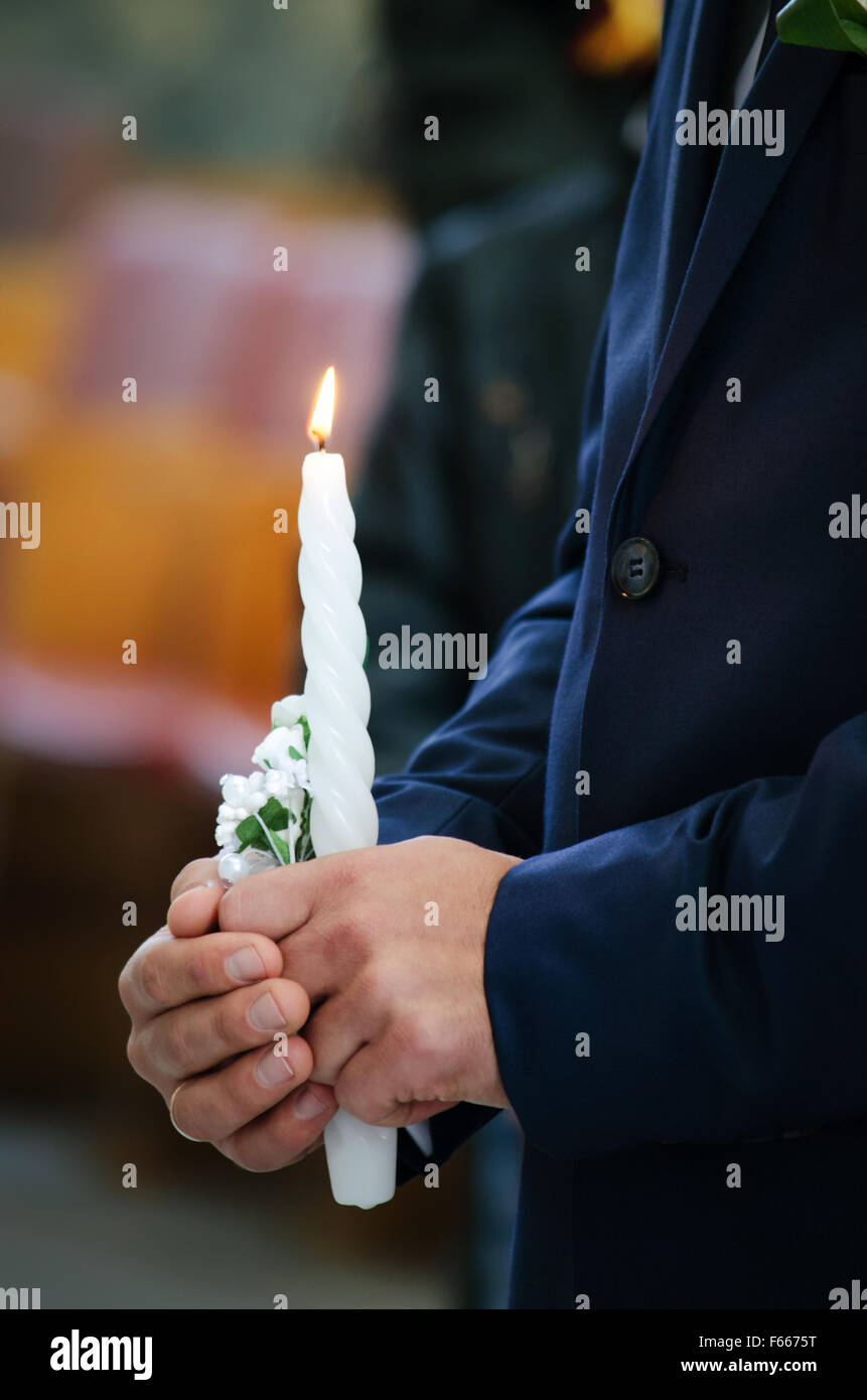 Candle in the hands Stock Photo - Alamy