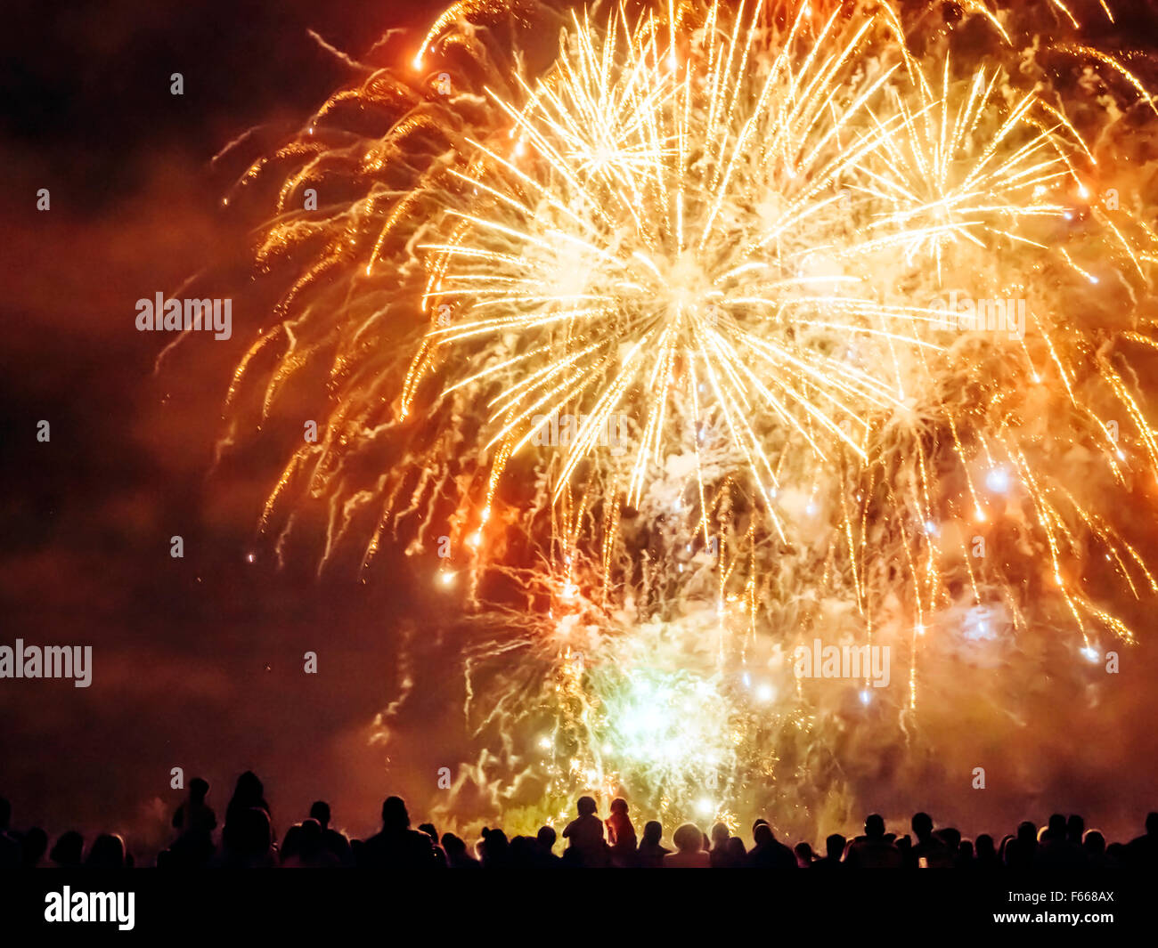 Crowd watching fireworks and celebrating Stock Photo - Alamy