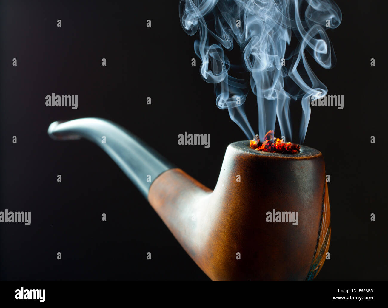 Smoking pipe with beautiful wisp of smoke. Closeup view Stock Photo - Alamy
