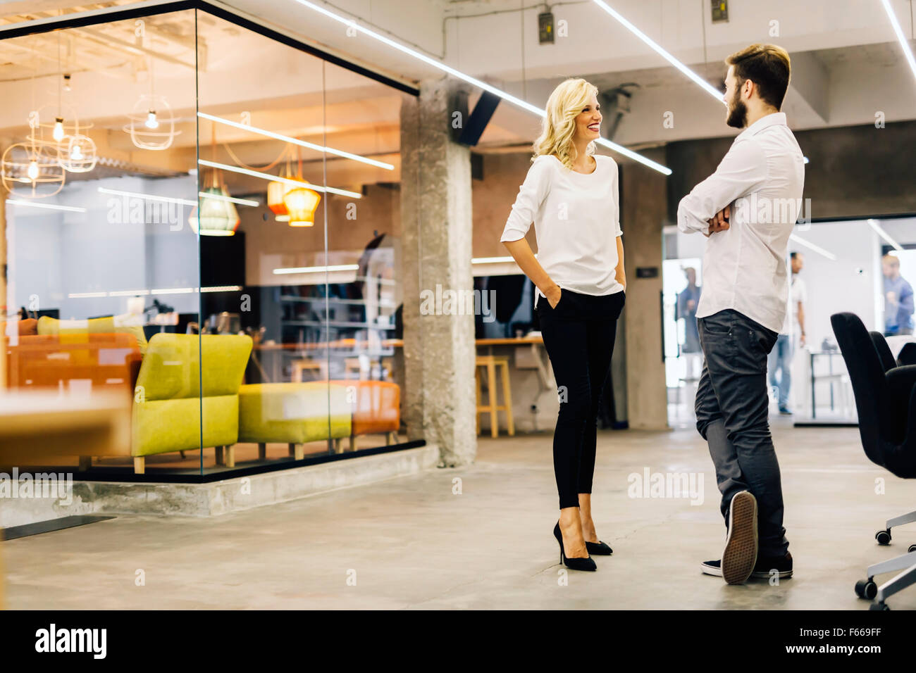 Two intelligent coworkers talking in a modern office Stock Photo - Alamy