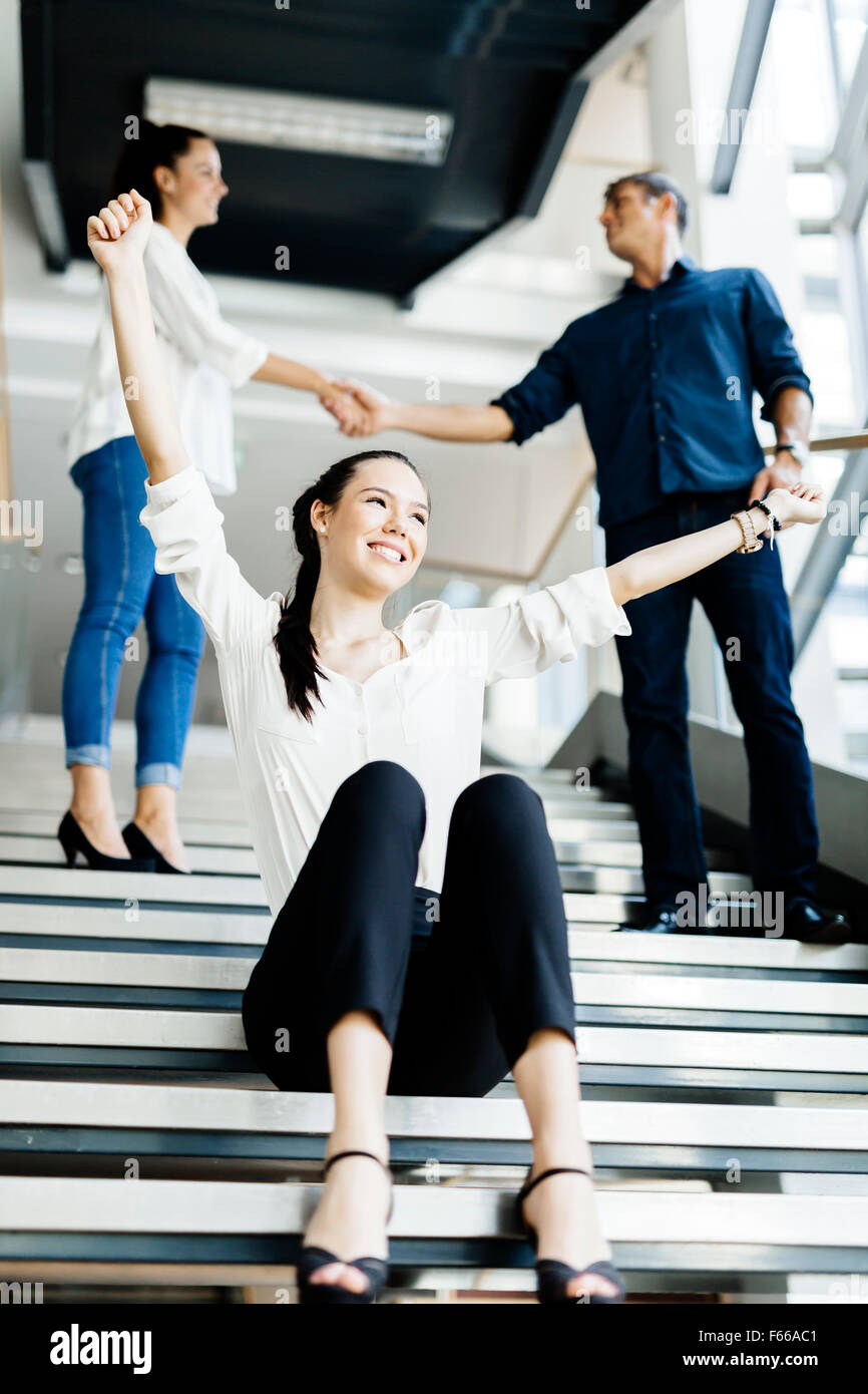 Group of business people shaking hands on stairs in a beautiful modern ...