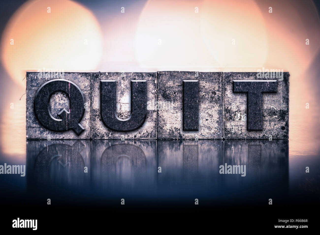 The word "QUIT" written in vintage ink stained letterpress type Stock ...