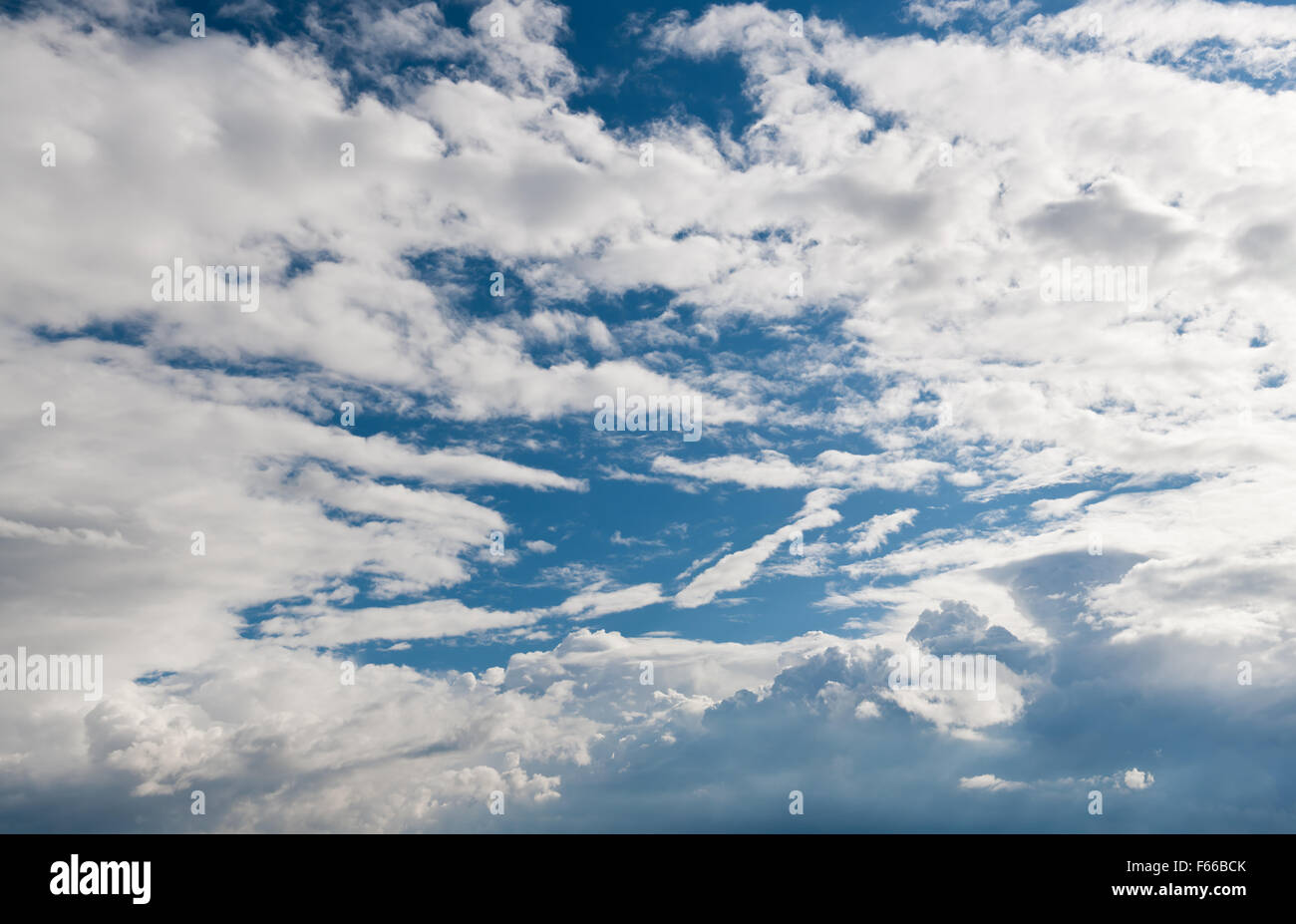 Growing Cumulus clouds formation, blue sunny sky and white escalating ...