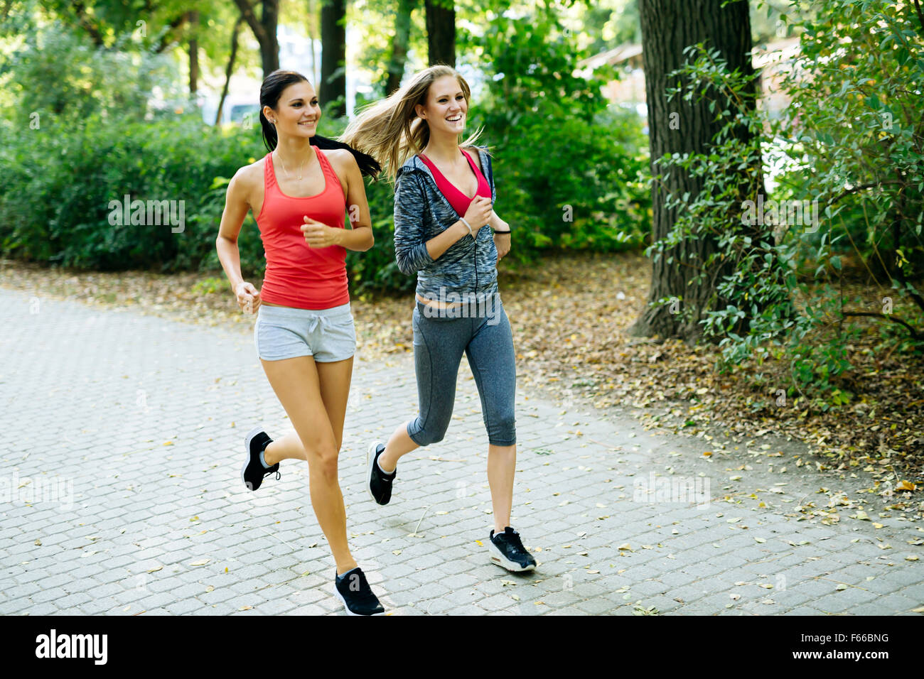 Young fit women jogging outdoors and staying fit Stock Photo - Alamy