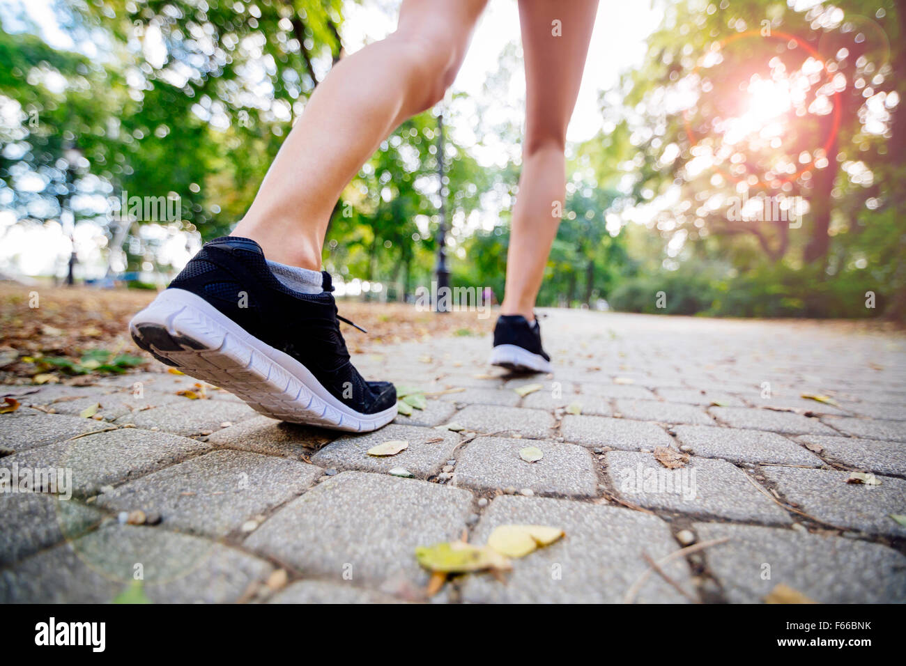 Closeup of female feet while jogging in nature outdoors in park Stock ...