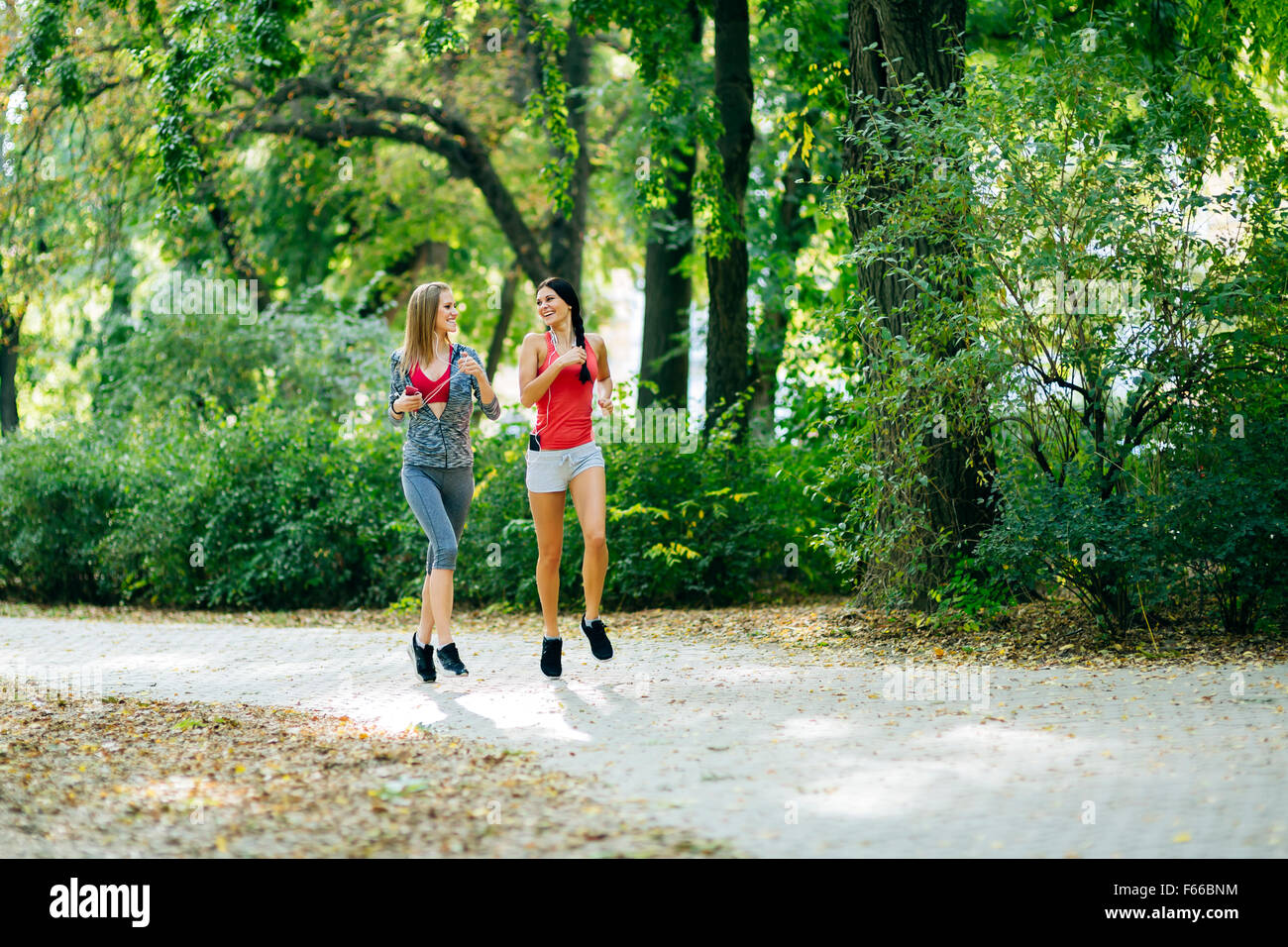 Beautiful sporty women jogging in park Stock Photo - Alamy