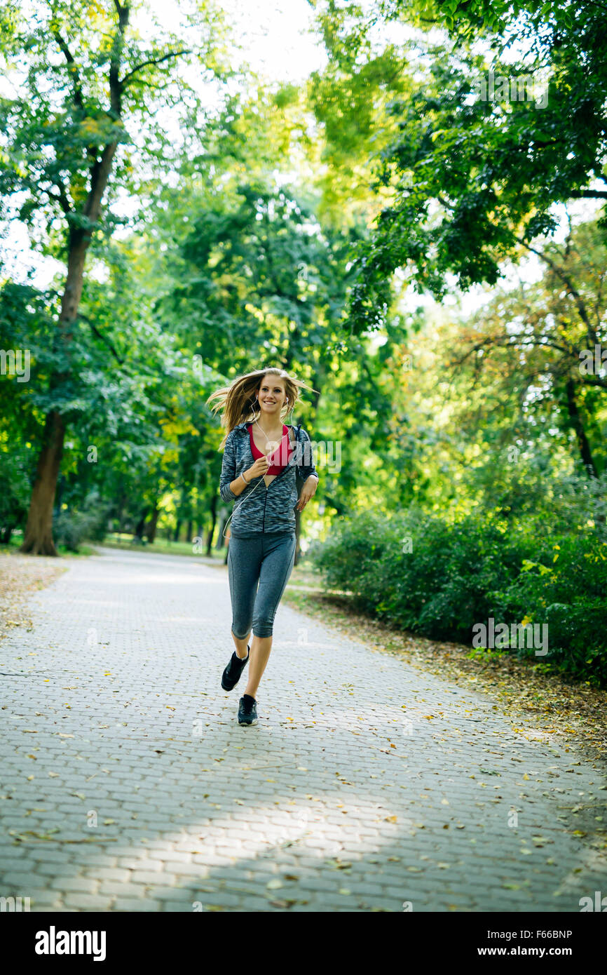 Young blonde woman jogging in park Stock Photo - Alamy Young blonde woman jogging in park Stock Photo - Alamy