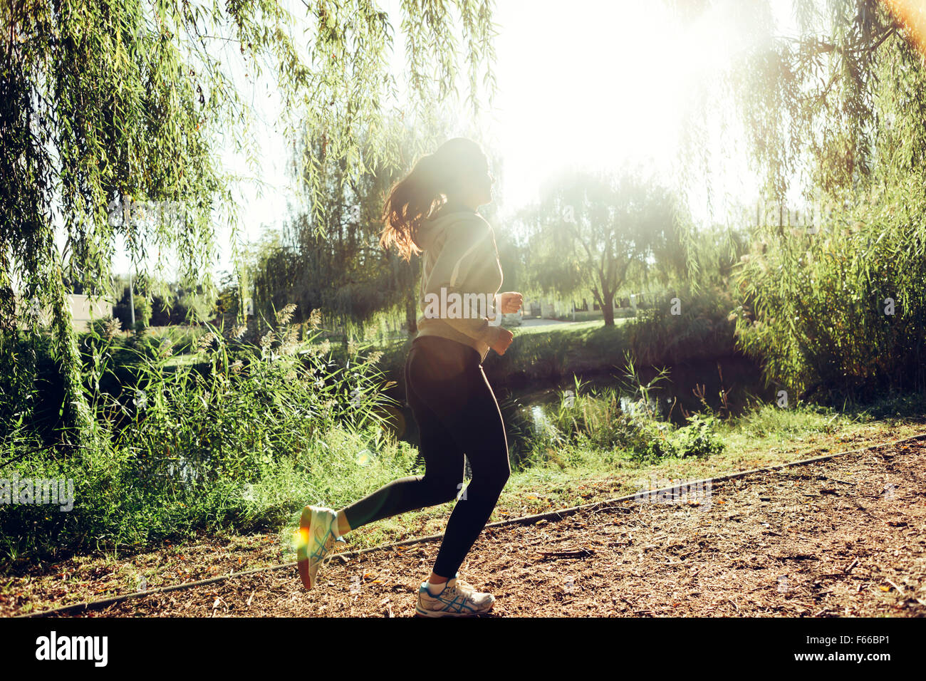 Fit beautiful woman jogging in park and staying healthy Stock Photo - Alamy