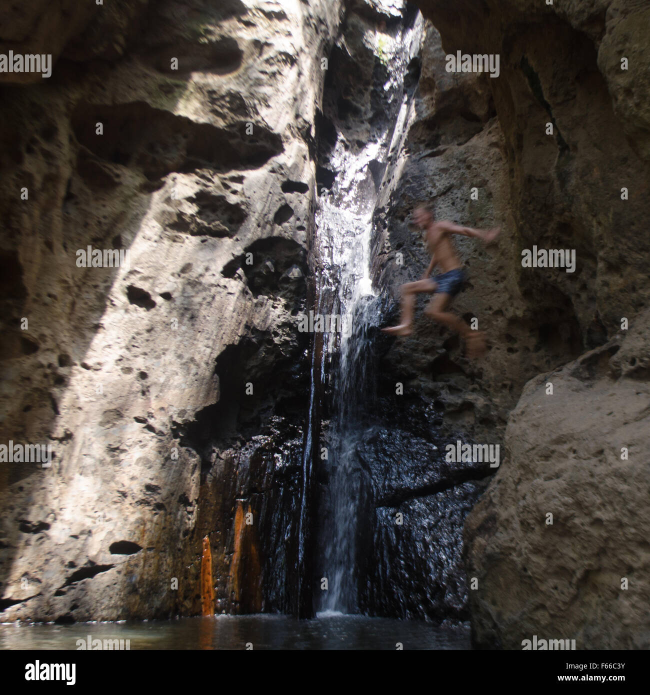 Motion blur of boy jumping into a lagoon inside a cave Stock Photo - Alamy