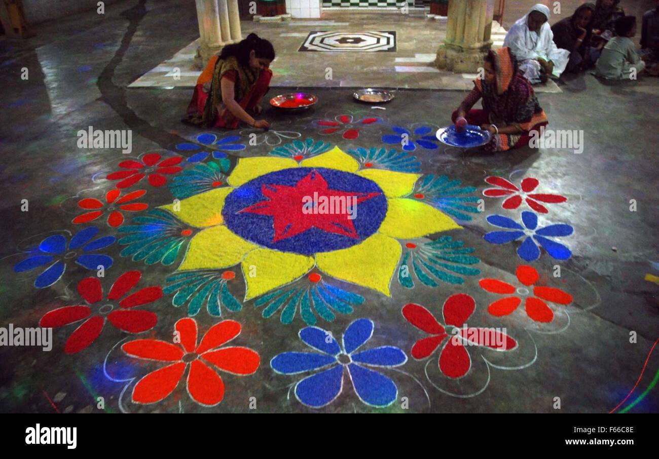 Hindu people are busy in making colorful Rangoli at their location on ...