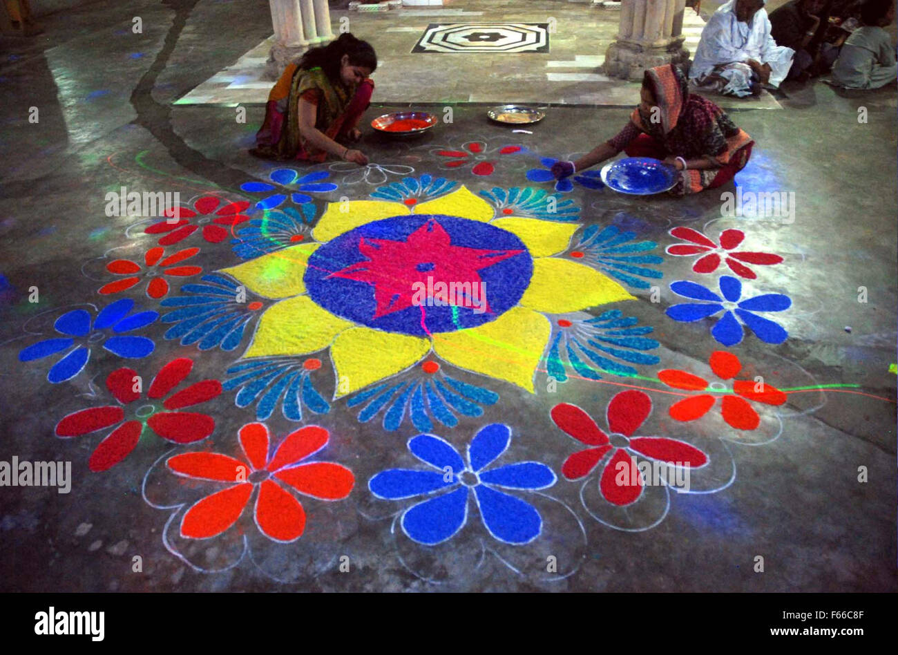 Hindu people are busy in making colorful Rangoli at their location on ...