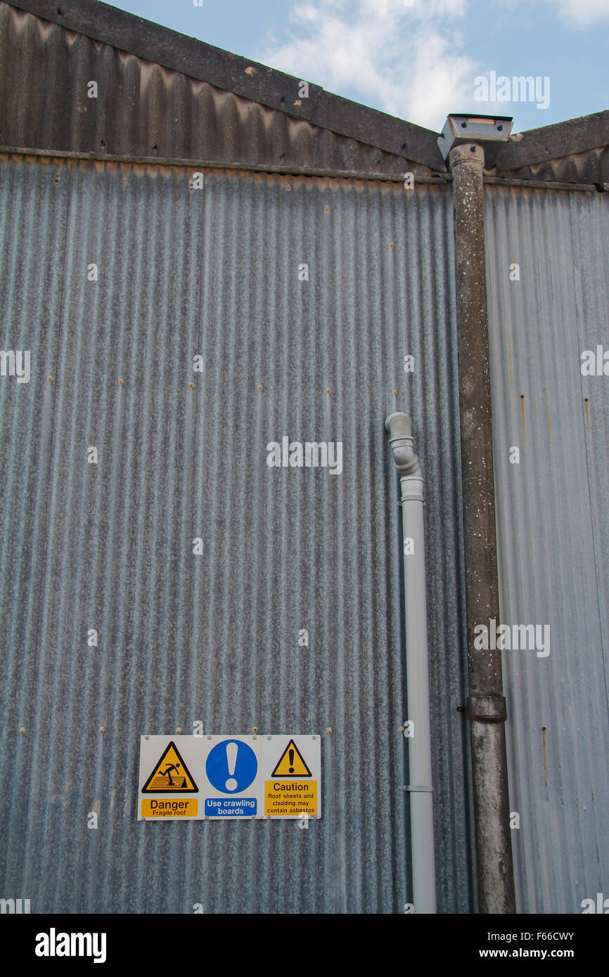 Warning sign caution roof sheets and cladding may contain asbestos hi ...