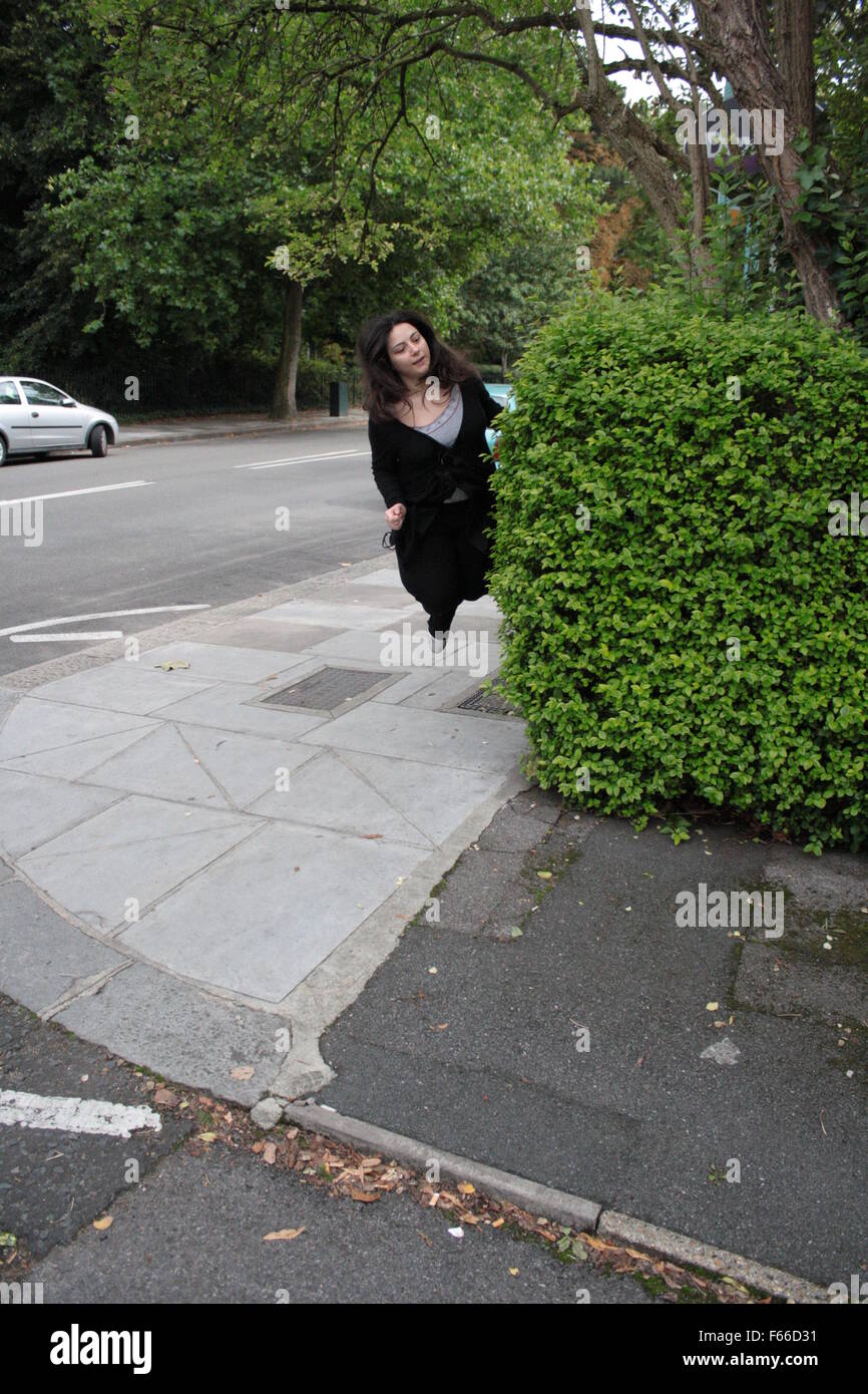 Woman floating around the corner Stock Photo - Alamy