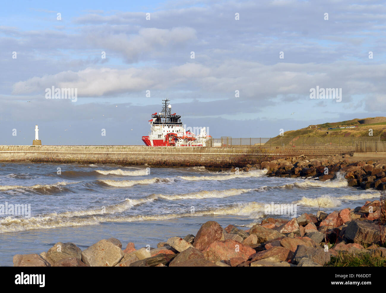 An oil rig supply vessel enters the North Sea from Aberdeen Harbour ...