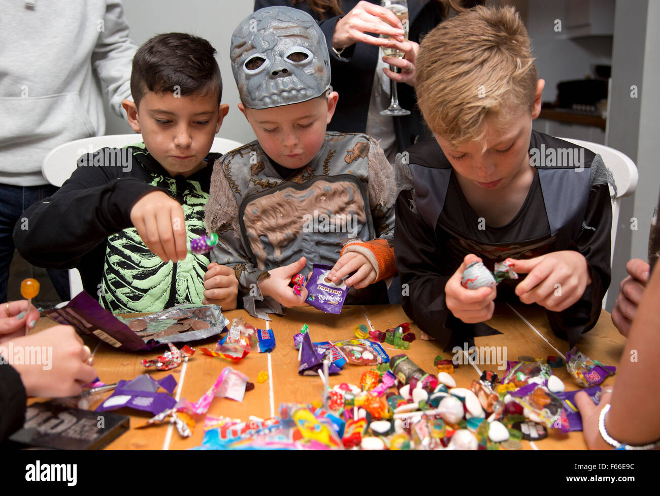 Children sharing out sweets on Halloween Stock Photo - Alamy