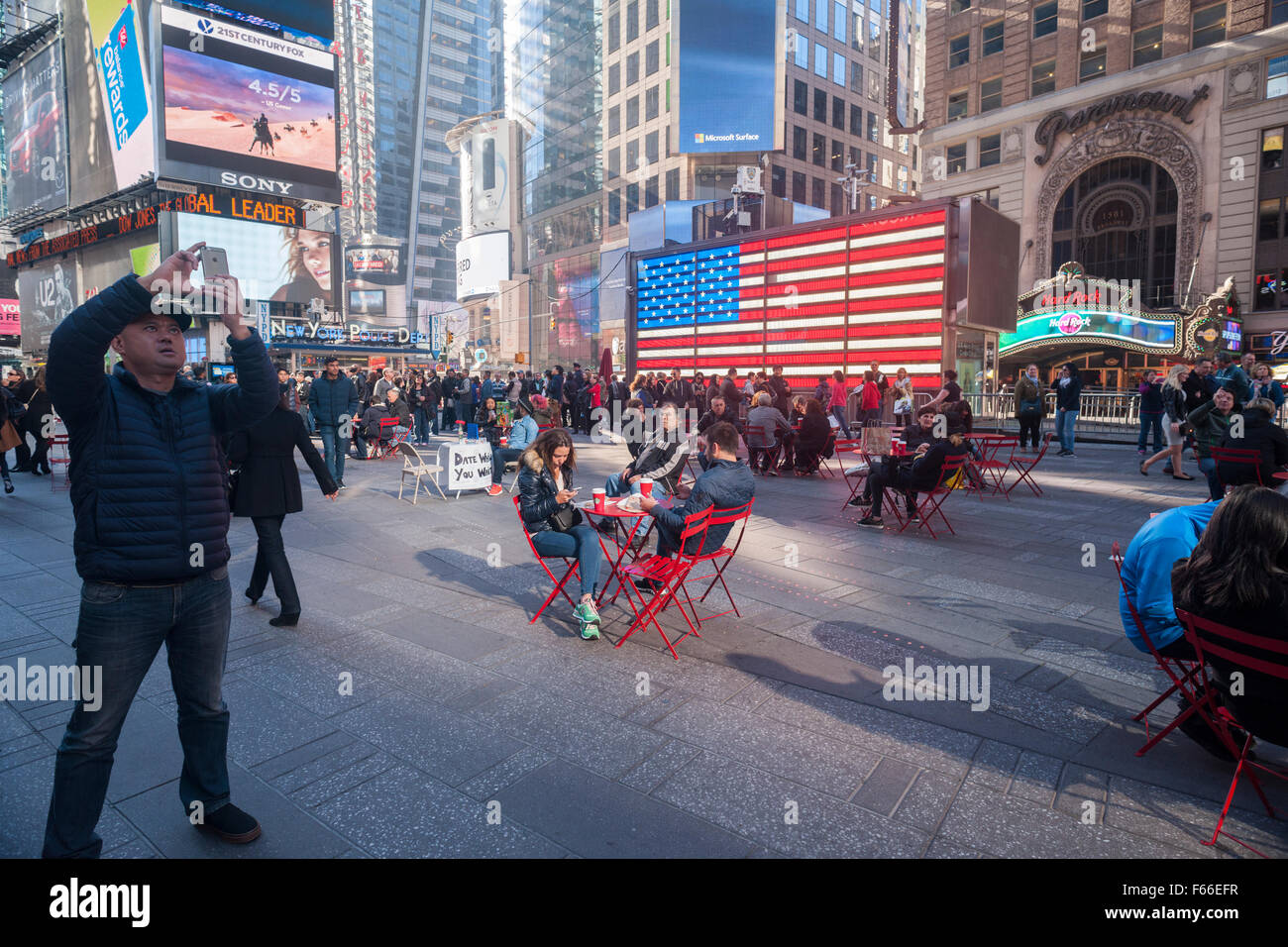 Tourists in Times Square go about the business of being tourists on ...