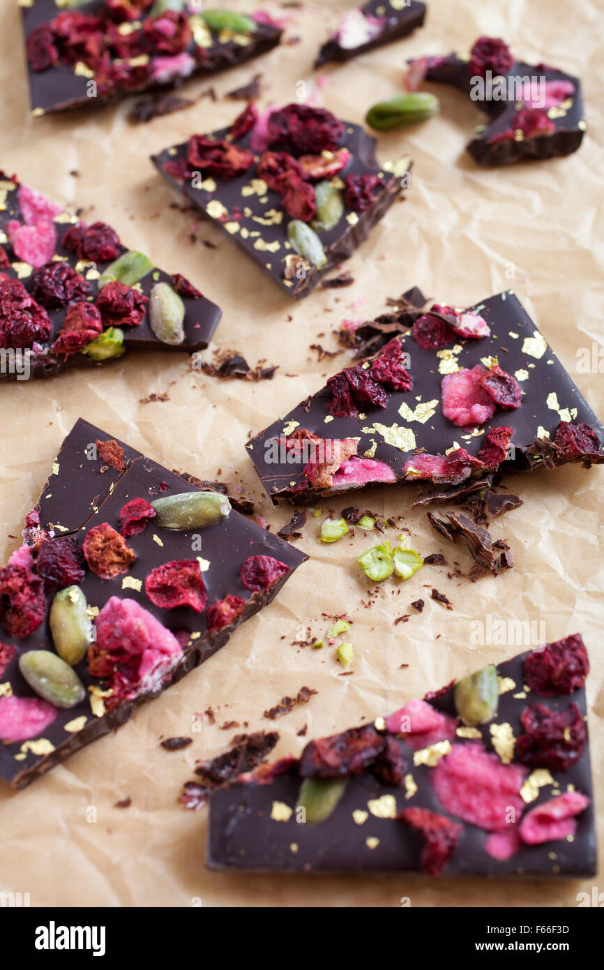 Handmade chocolate with berries, jpistachios and edible gold Stock ...