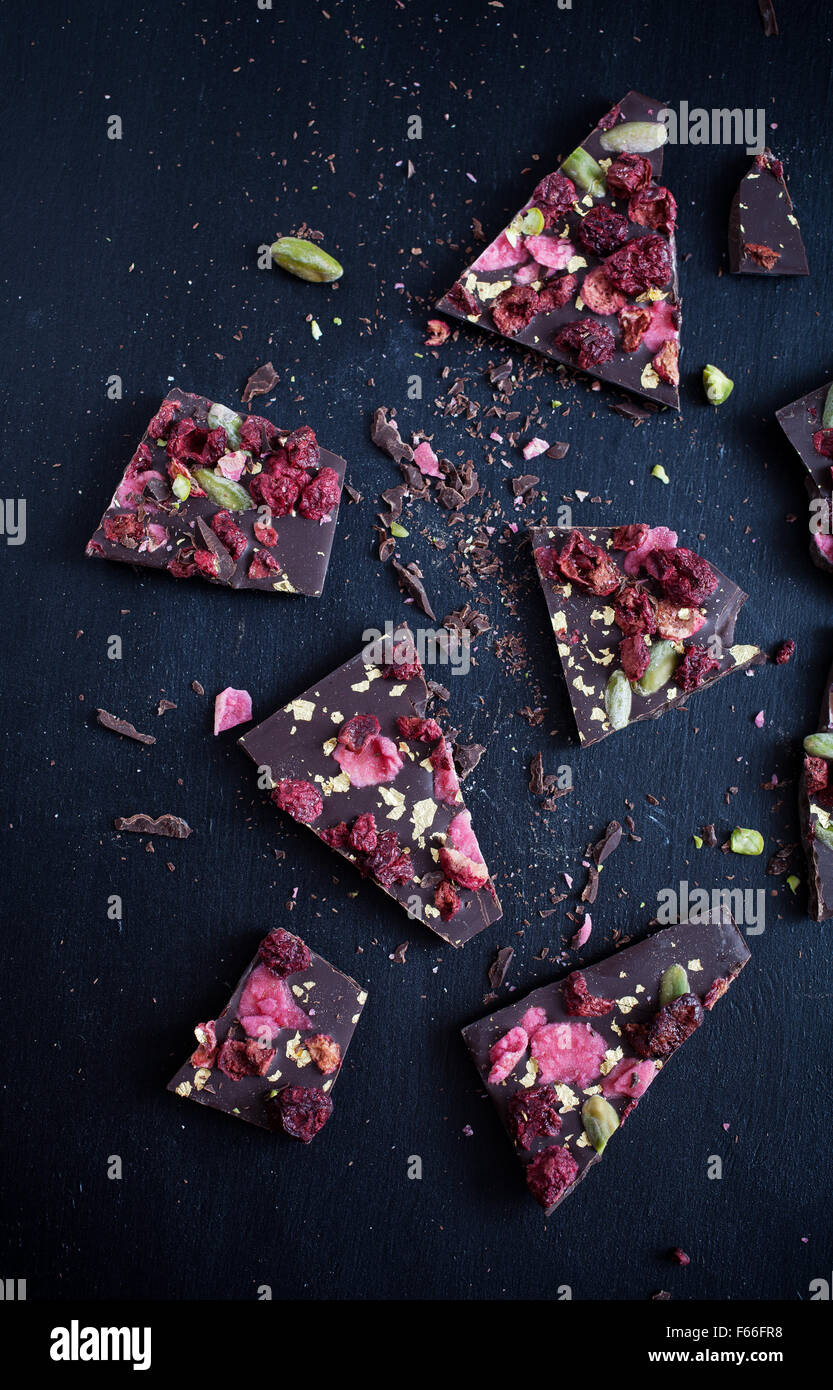 Handmade chocolate with berries, jpistachios and edible gold Stock ...