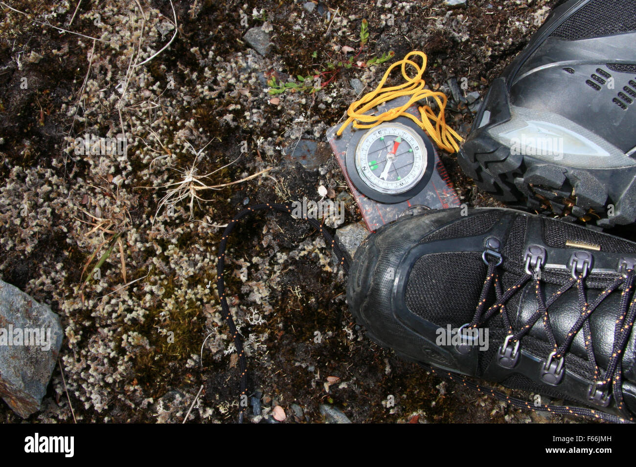 Hiking boots and compass Stock Photo - Alamy