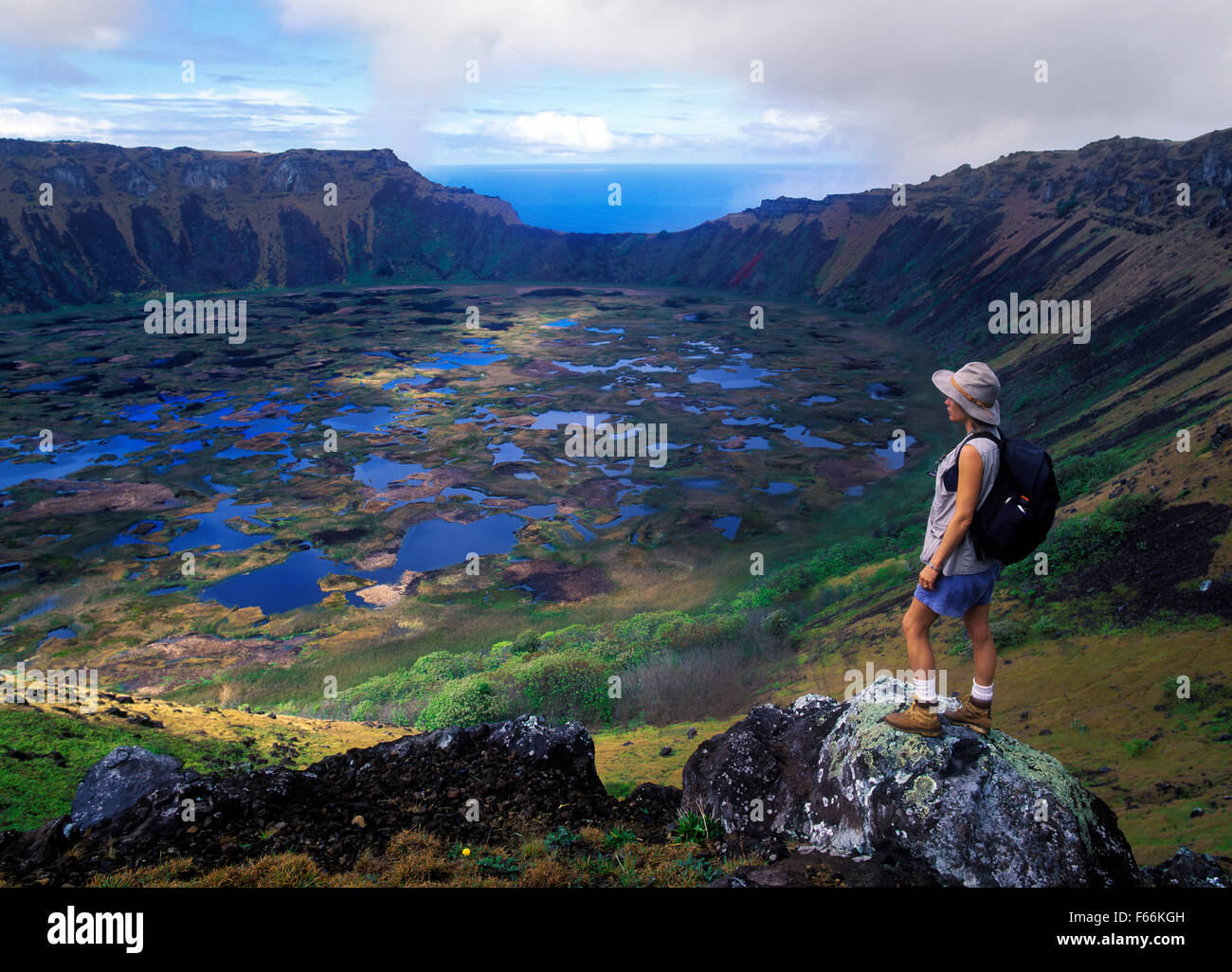 Chile, Easter Island, Hiker Overlooking the crater of Rano Kau Stock ...