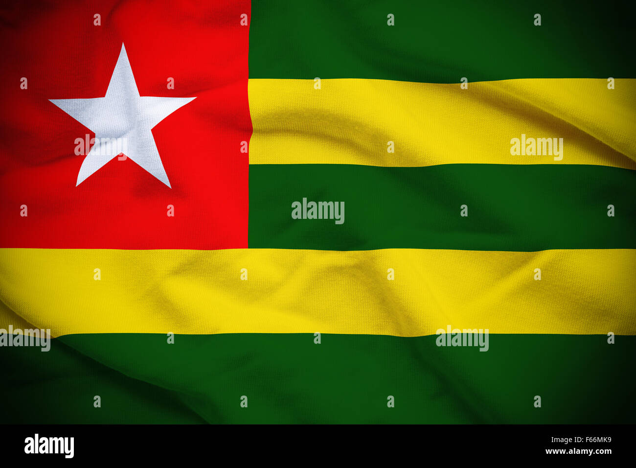 Wavy and rippled national flag of Togo background Stock Photo - Alamy