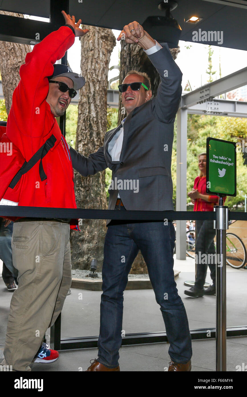(R to L) Shake Shack CEO Randy Garutti and the first customer pose for ...