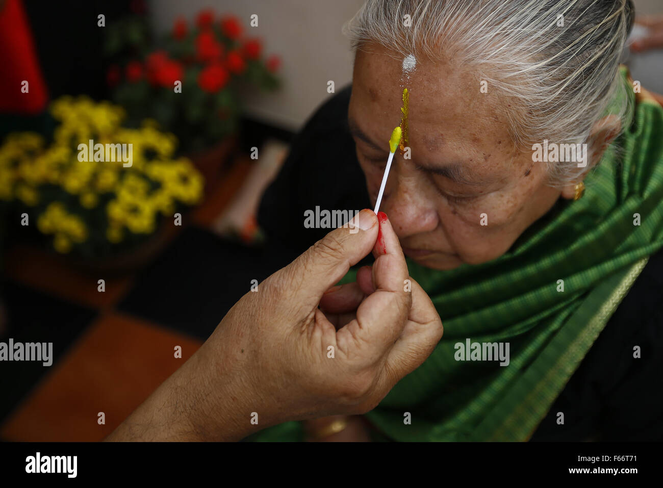 Kathmandu, Nepal. 13th November, 2015. A woman being applied with ...