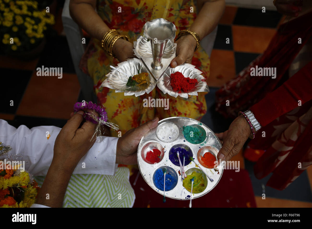Kathmandu, Nepal. 13th November, 2015. People hold colourful ''tika ...