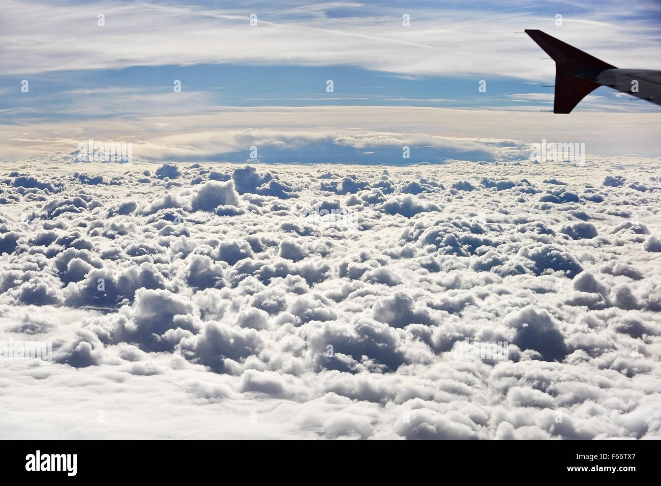 Shot taken through a window with an airplane wing and stormy clouds in ...