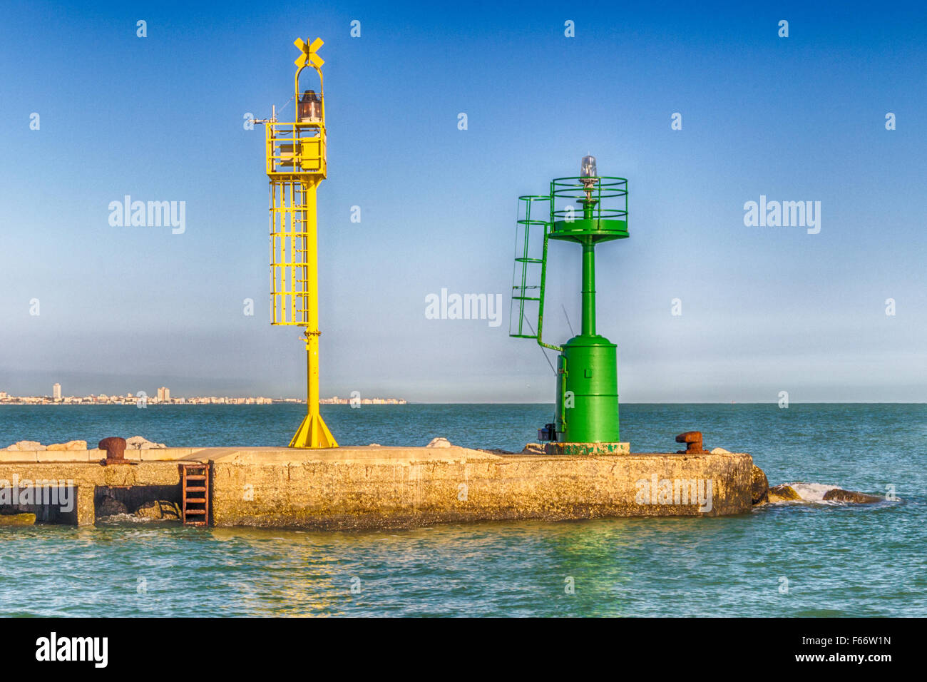 green and yellow lighthouses on a pier on the Adriatic Sea Stock Photo ...