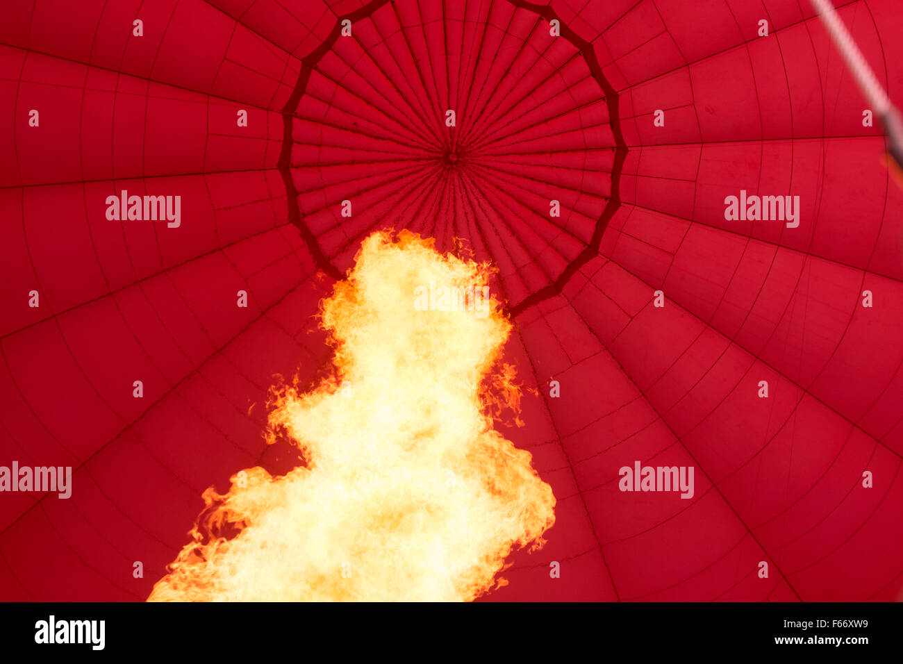 Gas flame heating hot air balloon to help it rise Stock Photo - Alamy
