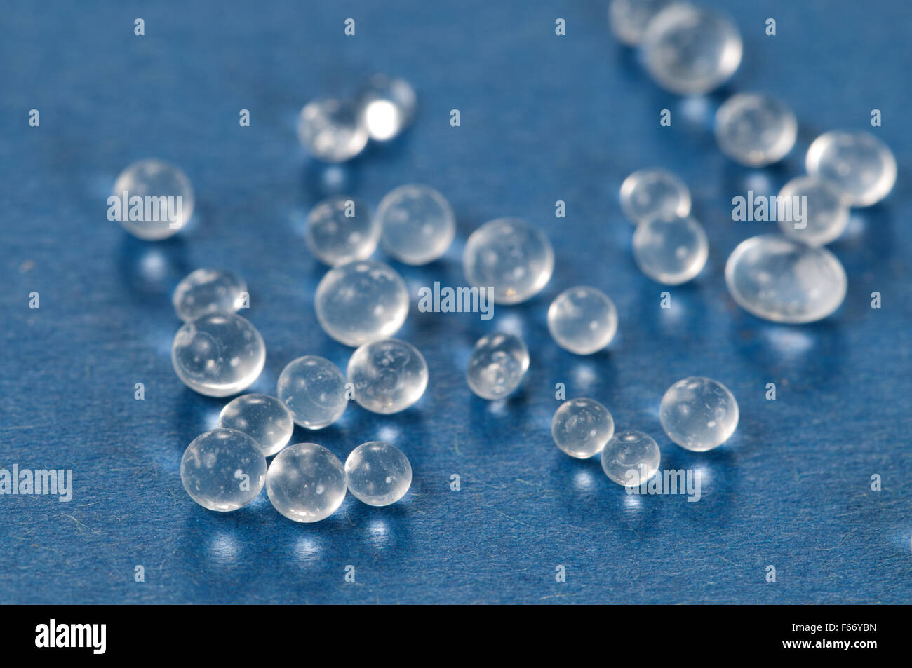 Silica gel pellets on a blue background Stock Photo - Alamy