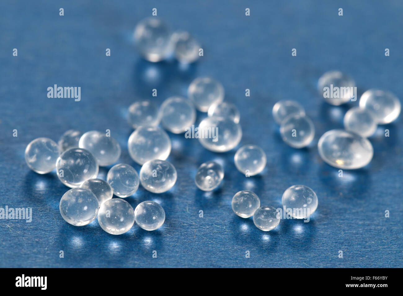 Silica gel pellets on a blue background Stock Photo - Alamy