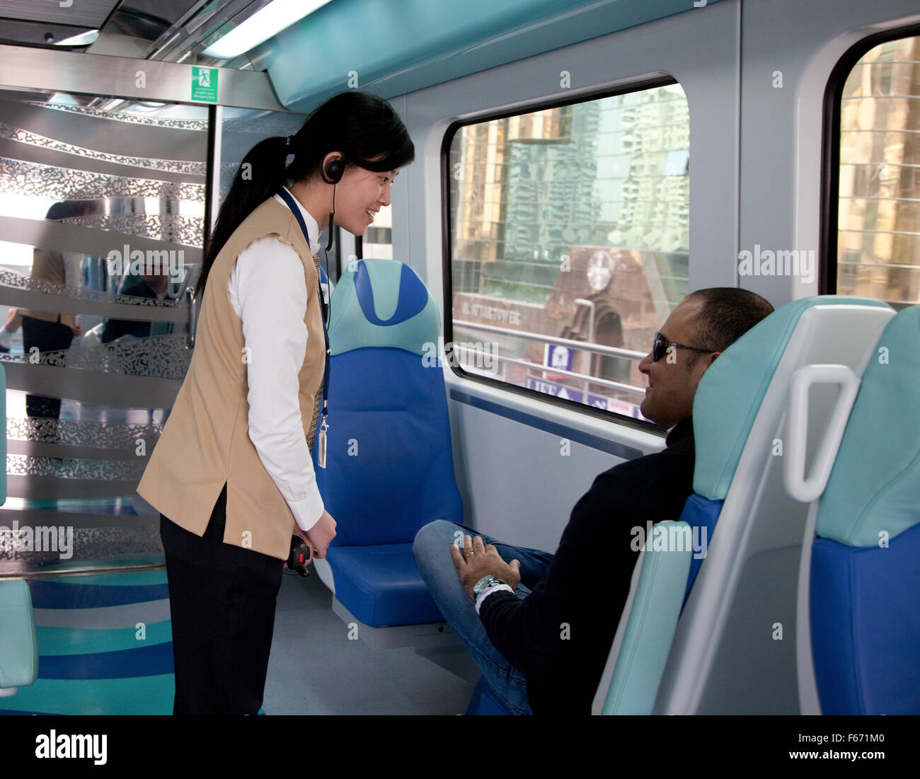 Station staff assist passengers on the Dubai Metro Stock Photo - Alamy
