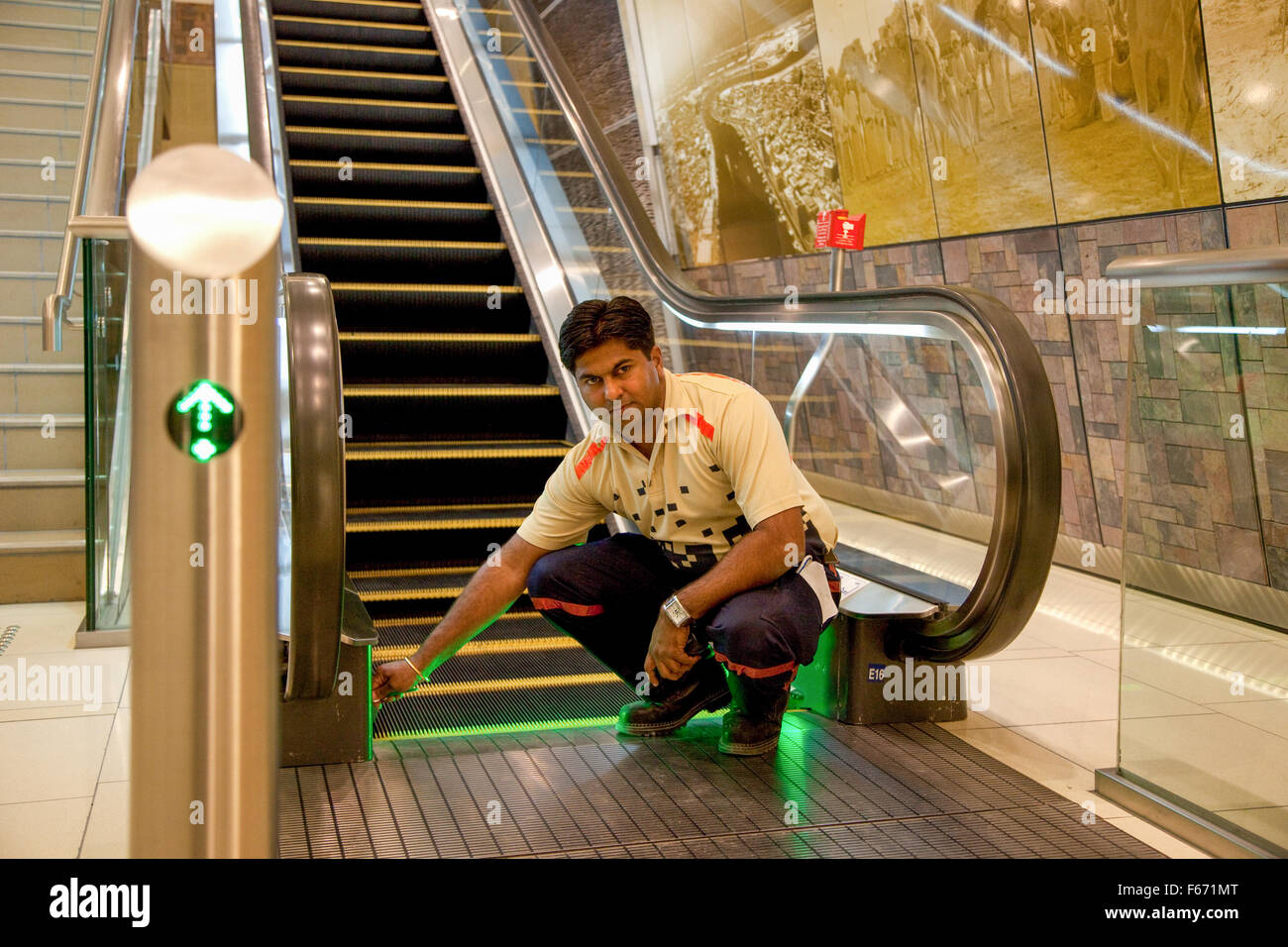 Maintenance man fixing escalator Dubai Metro Stock Photo - Alamy