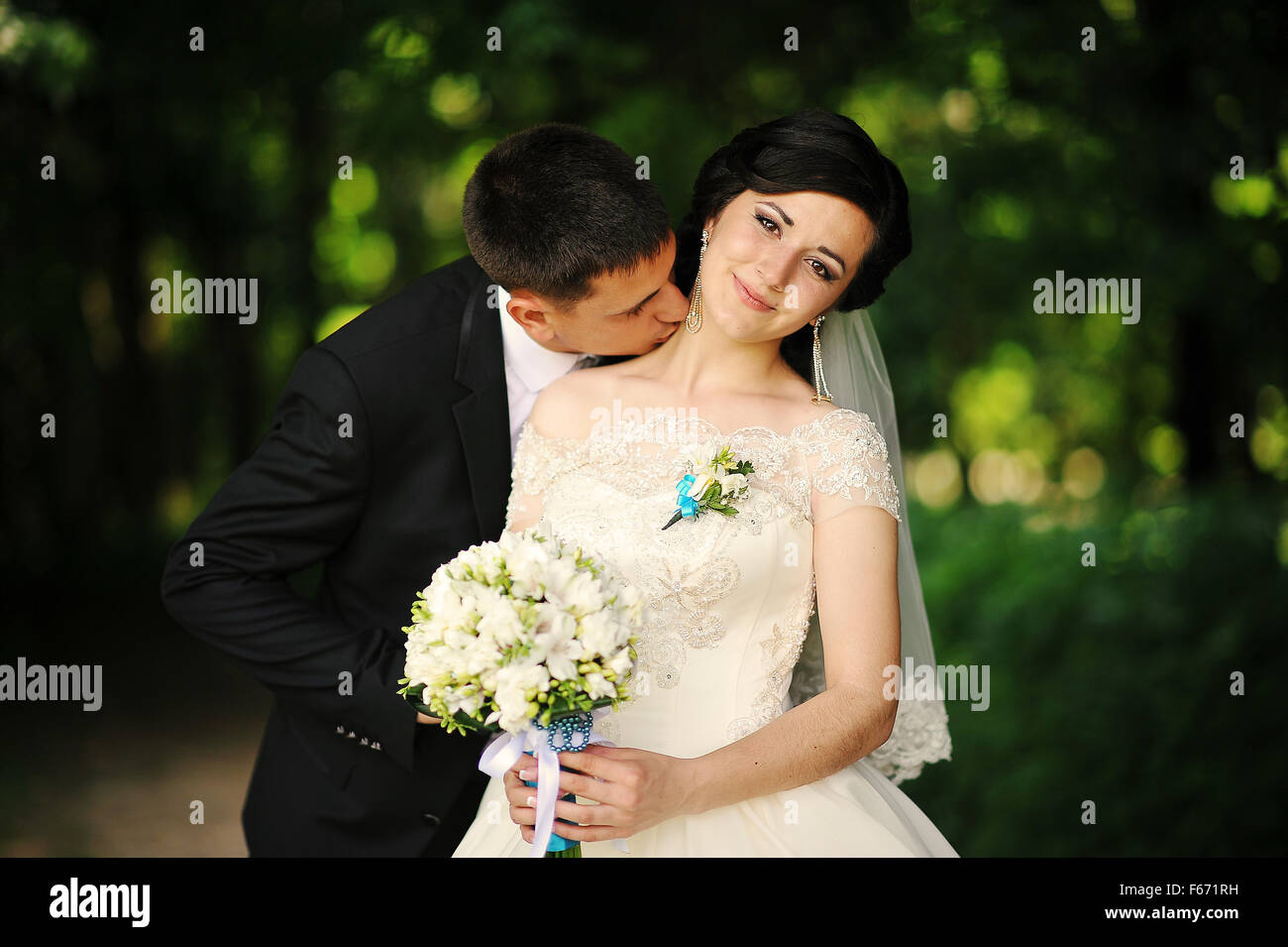 groom kisses on the neck bride Stock Photo - Alamy