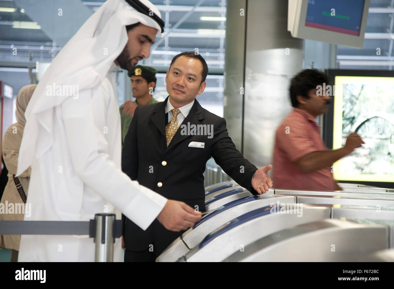Arab man in Dubai Metro being greeted by staff Stock Photo - Alamy